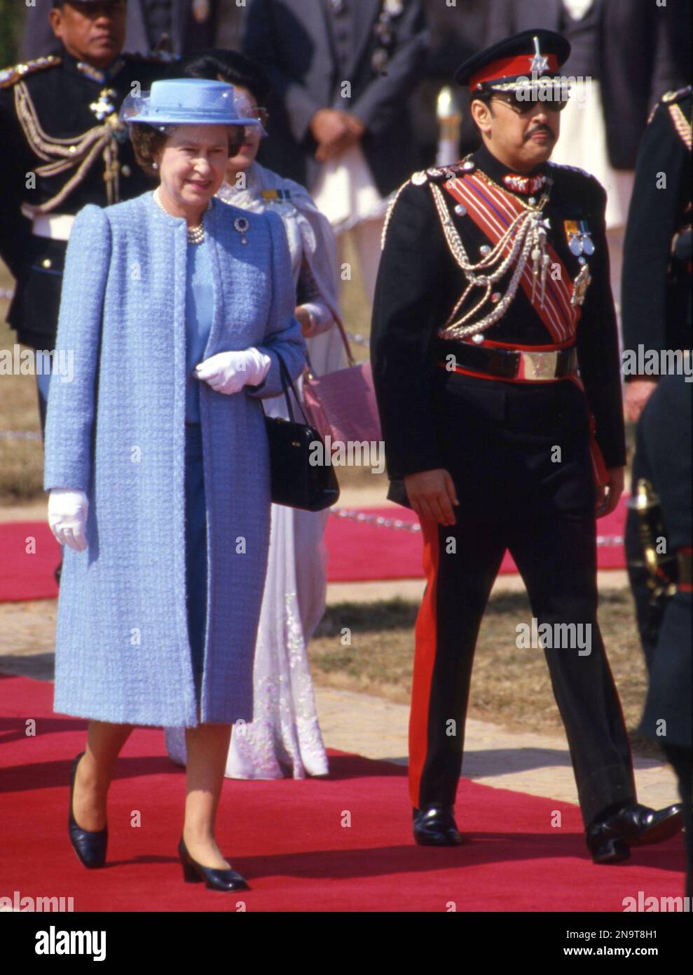 Britain's Queen Elizabeth II walks with Nepal's King Birendra, to her ...