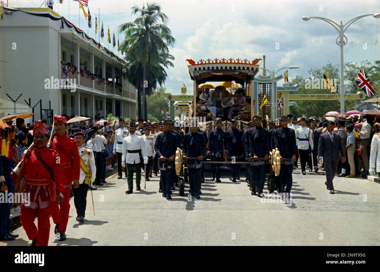 Footmen drag a golden chariot, in which are Britain's Queen Elizabeth ...