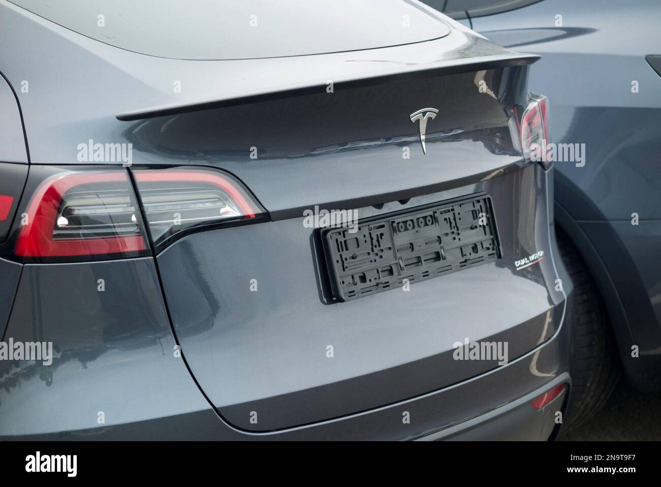 Tesla Electric vehicle EV cars waiting at a delivery collection car hub ...
