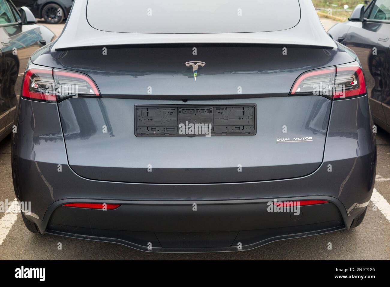 Tesla Electric vehicle EV cars waiting at a delivery collection car hub ...