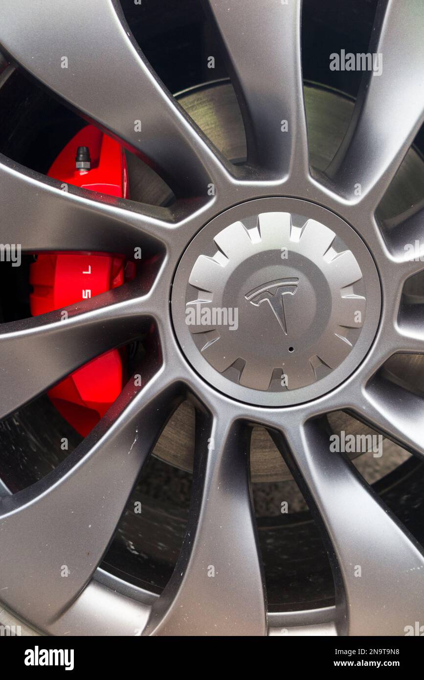 Front wheel with a red brake mechanism on a Tesla electric vehicle ...