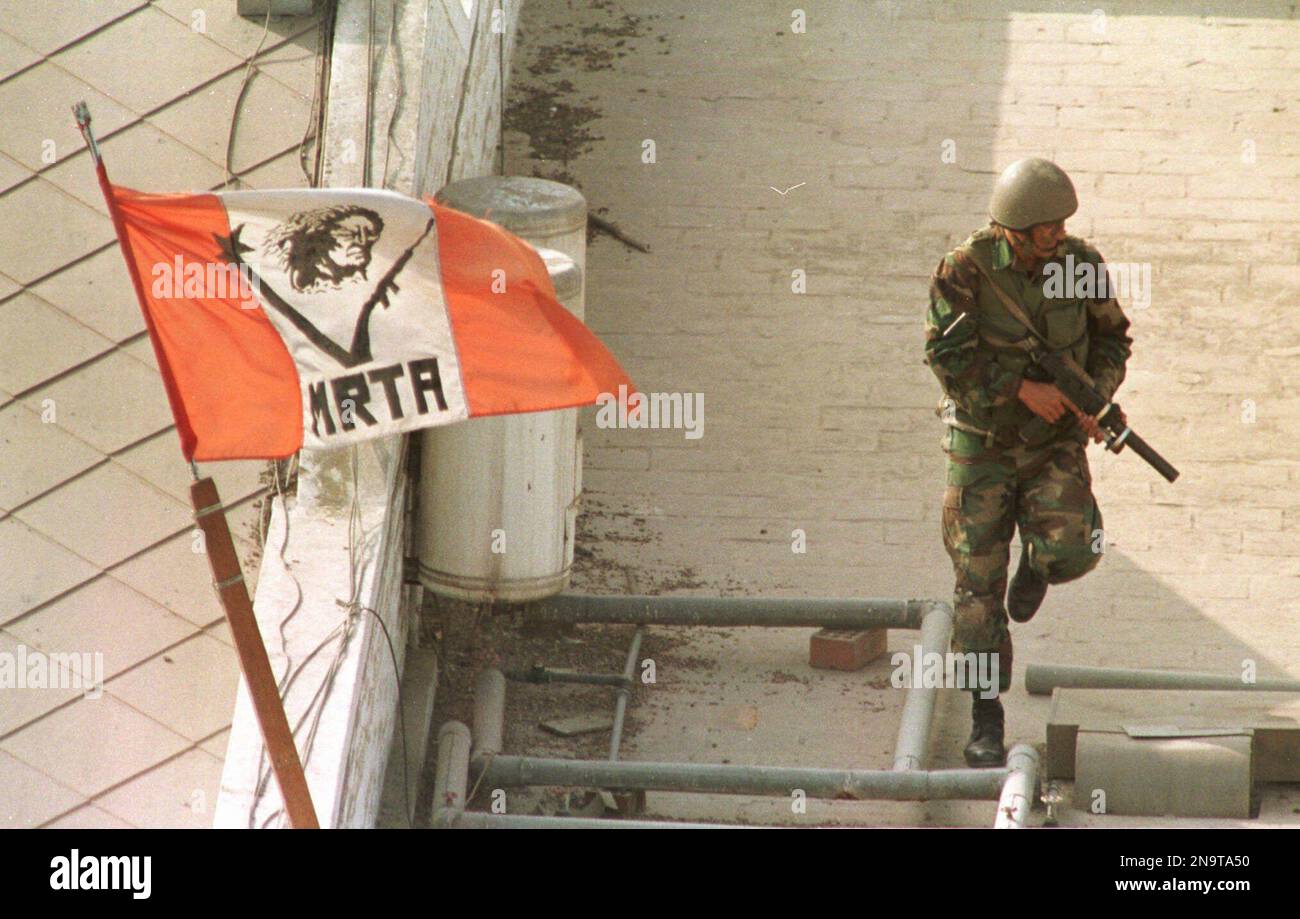 FILE - In this April 22, 1997 file photo, a soldier runs past the flag ...