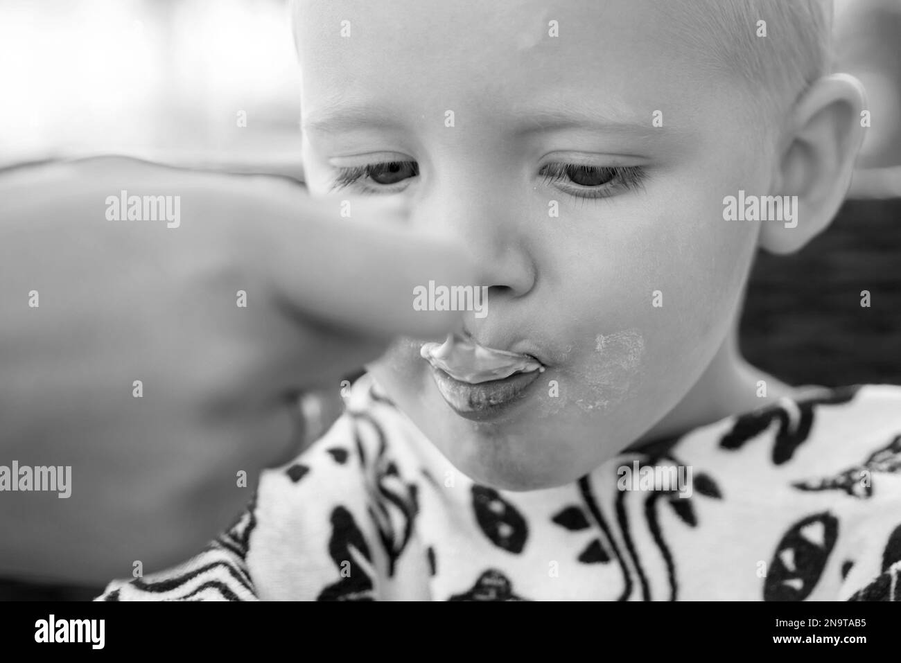 Kid food. Feeding baby boy with spoon. Fatherhood, mother or sister ...
