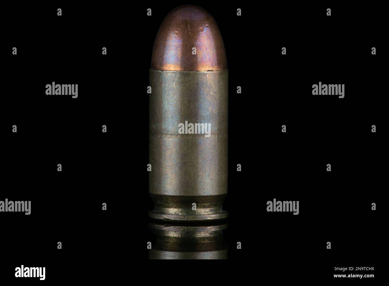 45 caliber round isolated on black background with reflexion Stock ...