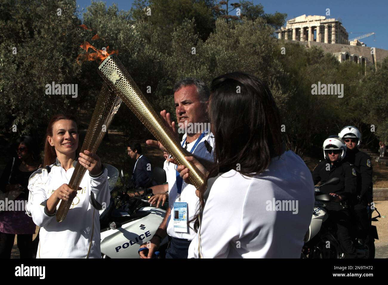 Torchbearer Artemis Ignadiou, left, choreographer of the Olympic flame ...