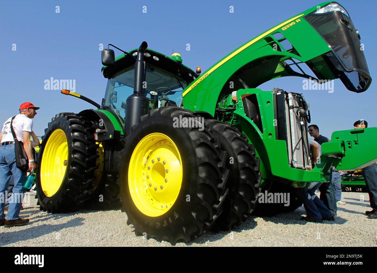 In an Aug. 31, 2011 photo people examine John Deere farming equipment ...