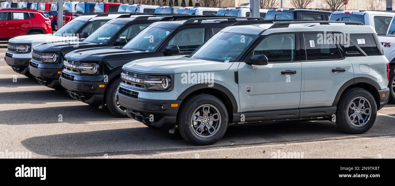 A different colored Ford Bronco SUVs lined up for sale at a dealership ...
