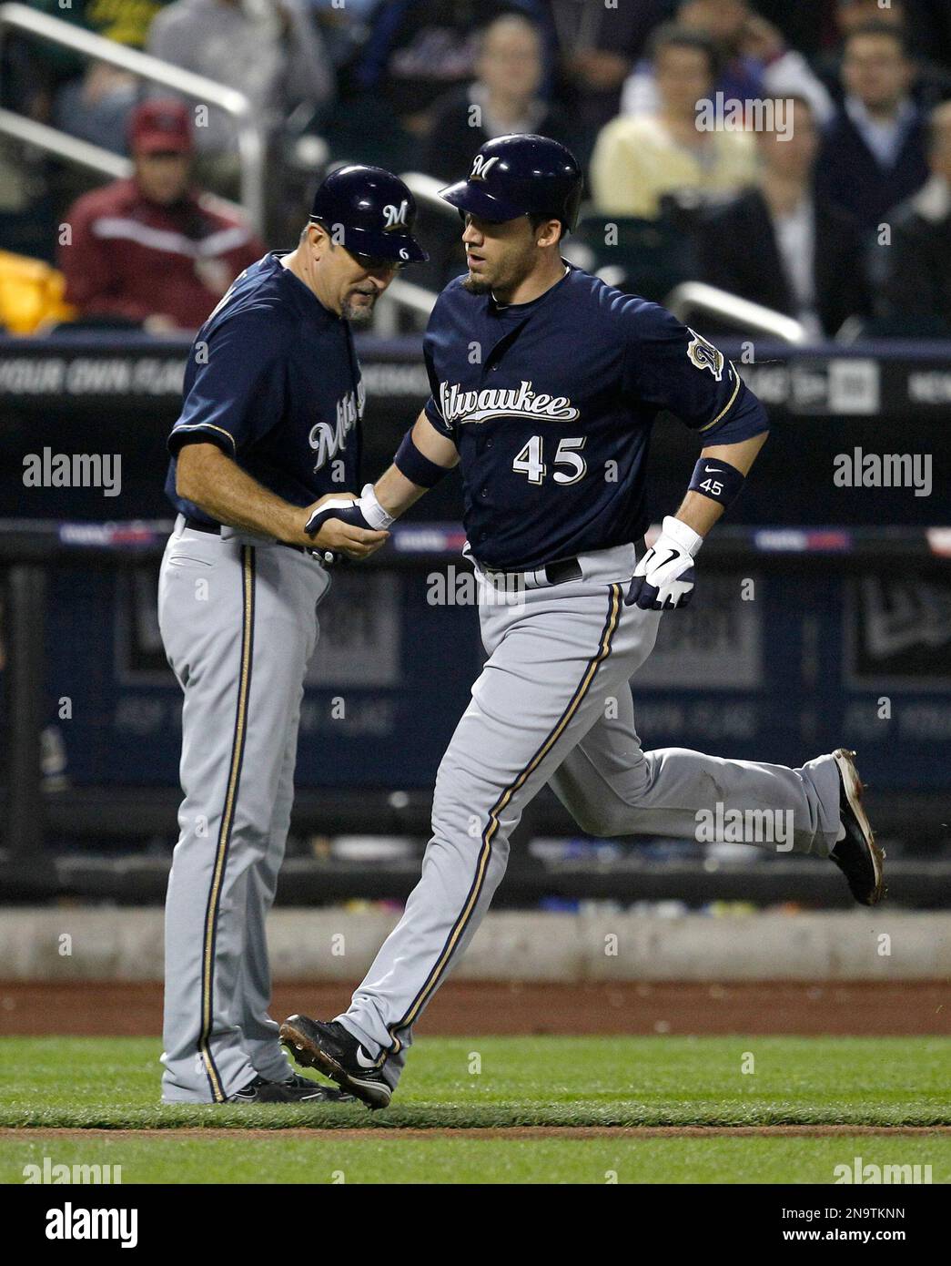 Milwaukee Brewers third base coach Ed Sedar congratulates Travis ...