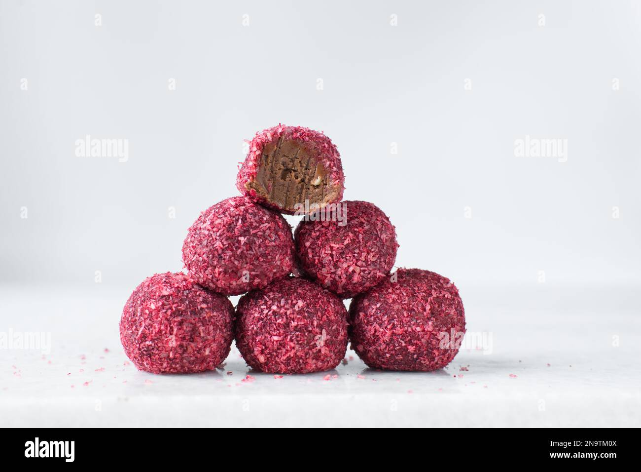 Raspberry coconut and chocolate truffles, homemade chocolate bonbons on ...