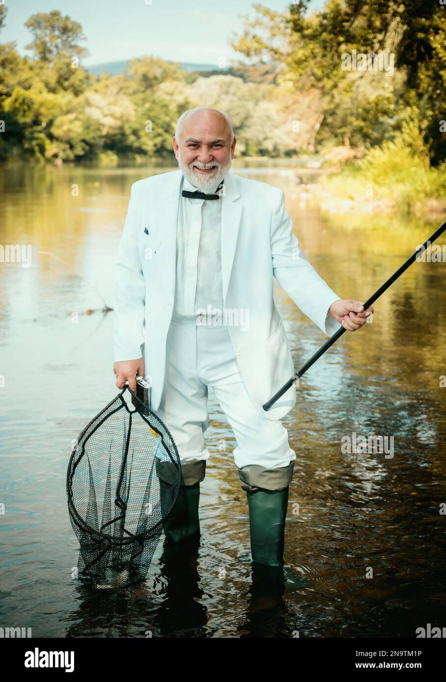 Senior man on waders hi-res stock photography and images - Alamy