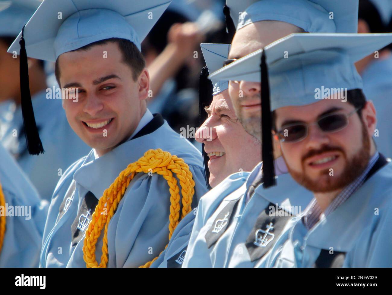 Columbia University janitor Gac Filipaj, second from left, smiles while ...