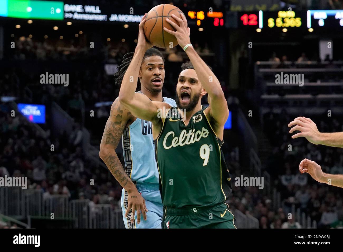 Boston Celtics guard Derrick White (9) drives toward the basket past ...