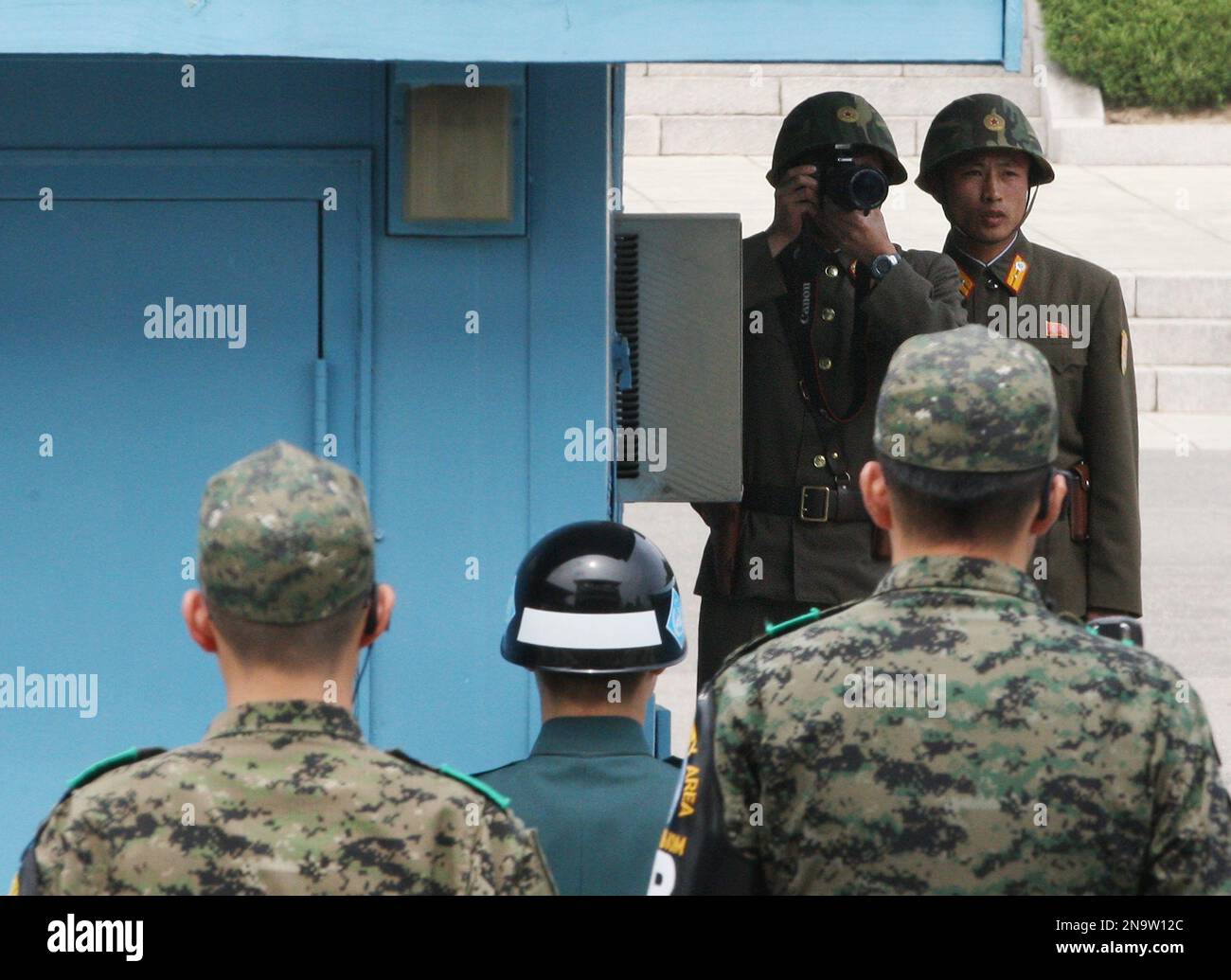 A North Korean soldier takes pictures of the southern side as Danish ...