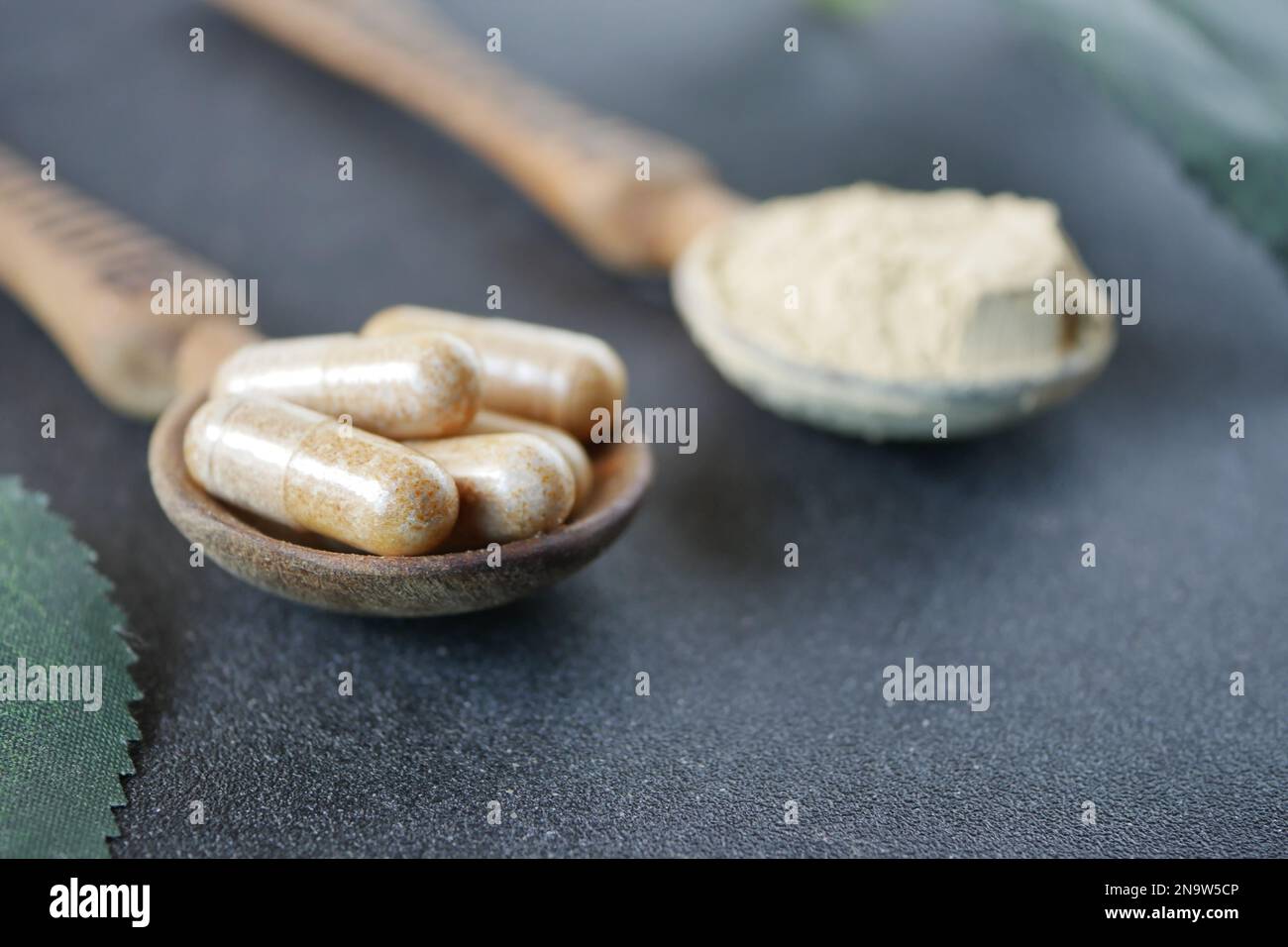 herbal medicine capsule and powder on a spoon Stock Photo - Alamy