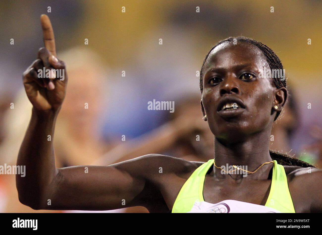 Pamela Jelimo of Kenya reacts as she crosses the finish-line to win the ...