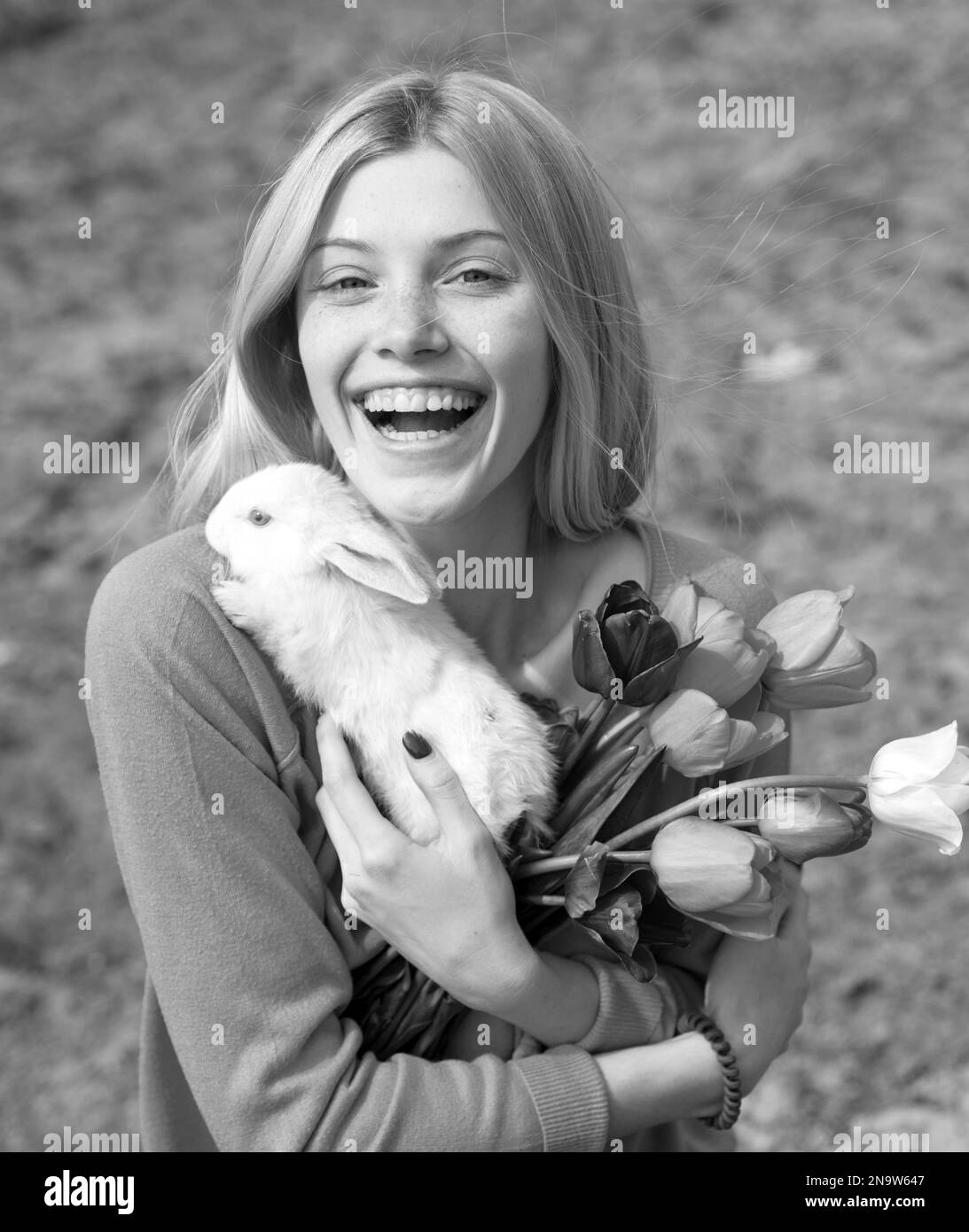 Lovely woman hold white rabbit. Portrait of young woman posing with ...