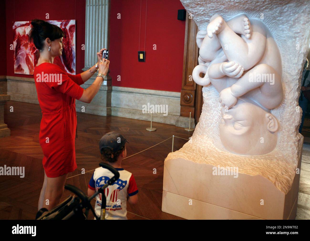 Visitors look at the British artist Marc Quinn's work "Evolution", at ...