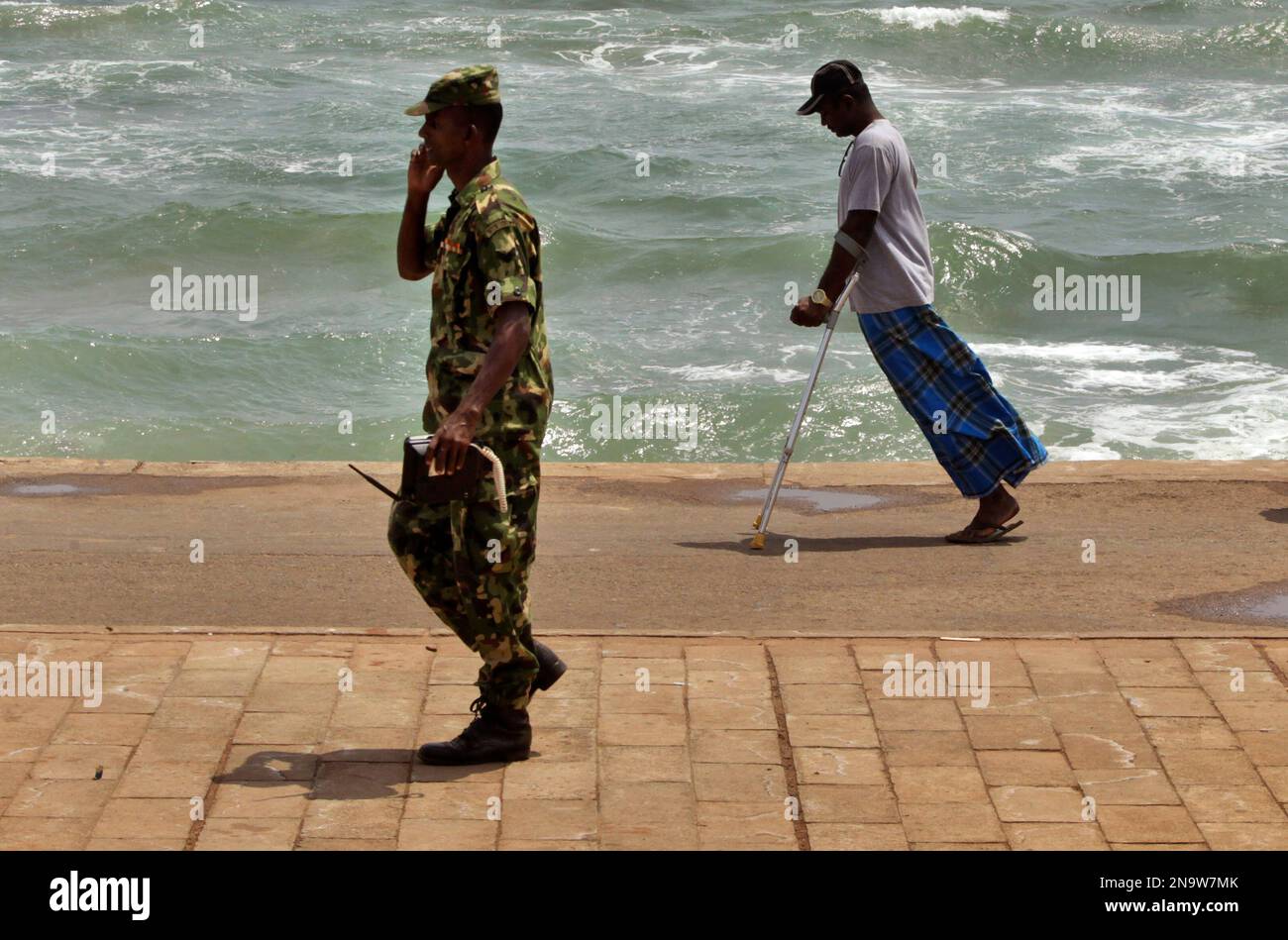 A Sri Lankan army soldier stands guard as a former Tamil tiger ...