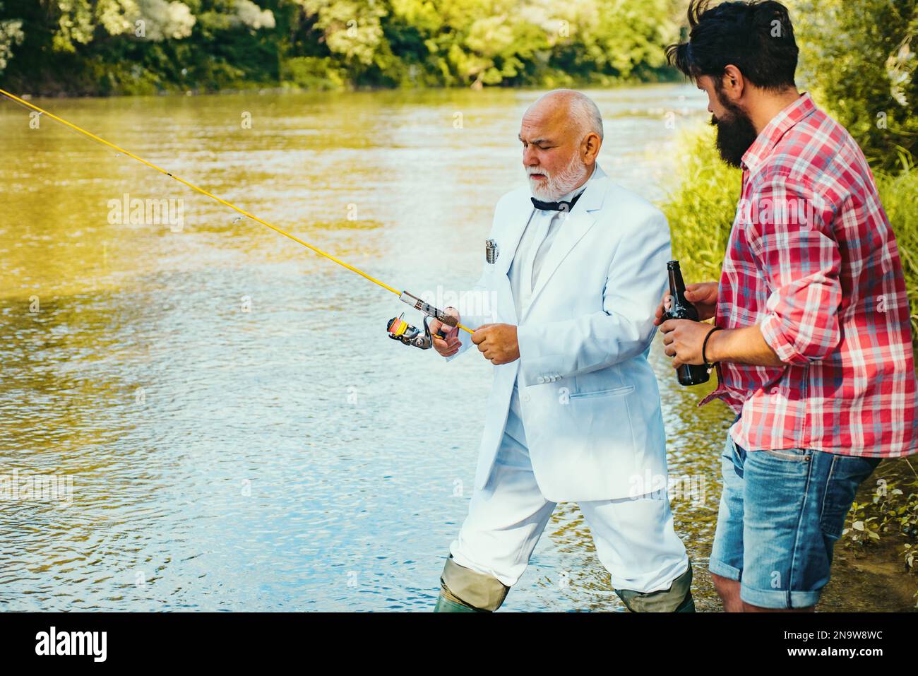 Two male friends fishing together. Fishing and drinking beer. Start ...