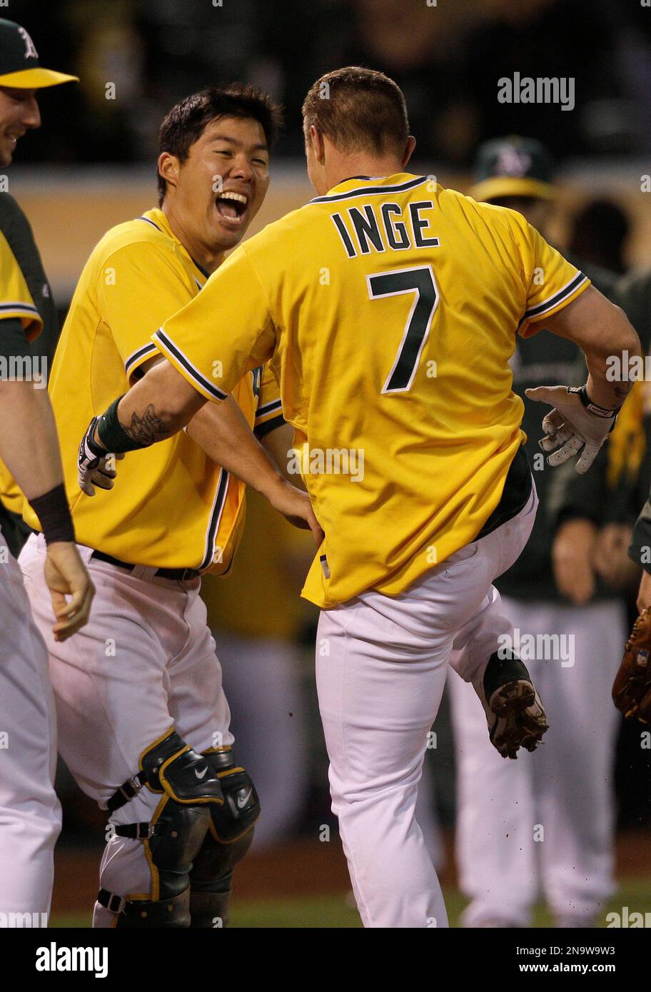 Oakland Athletics' Brandon Inge (7)celebrates with Kurt Suzuki after ...
