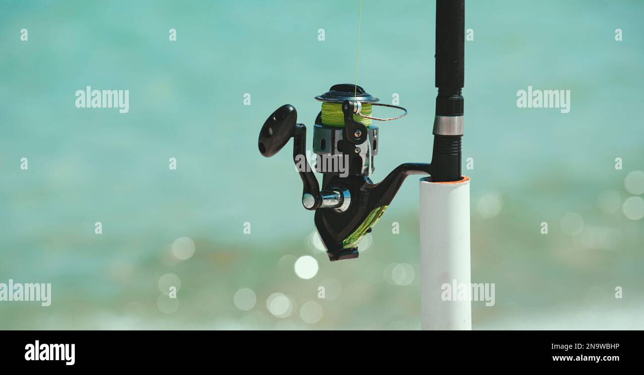 Summer vacation. Fishing rod at sea. Spinner, fish-rod. Relaxing ...