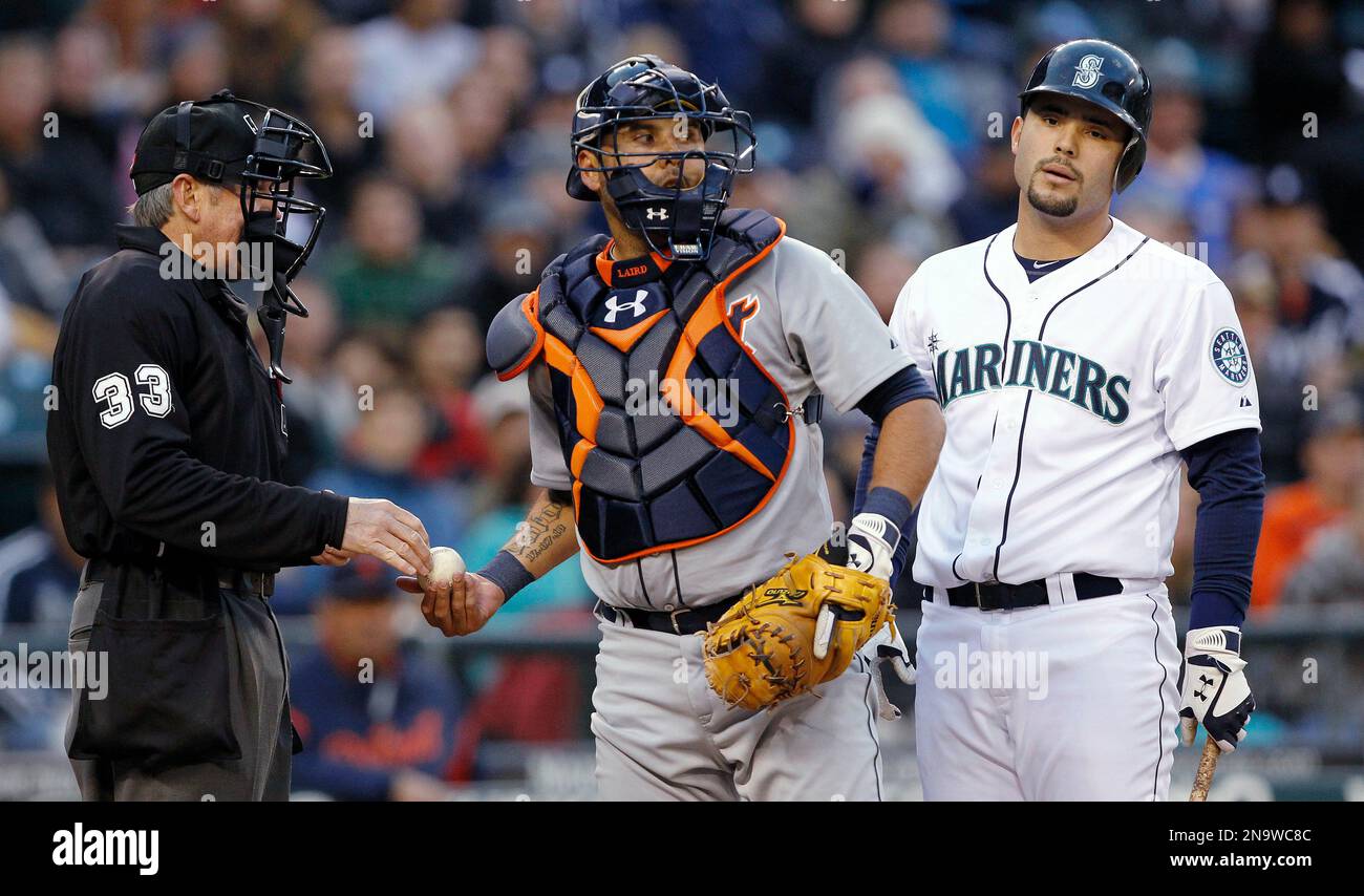 Seattle Mariners' Jesus Montero, right, reacts after striking out as ...