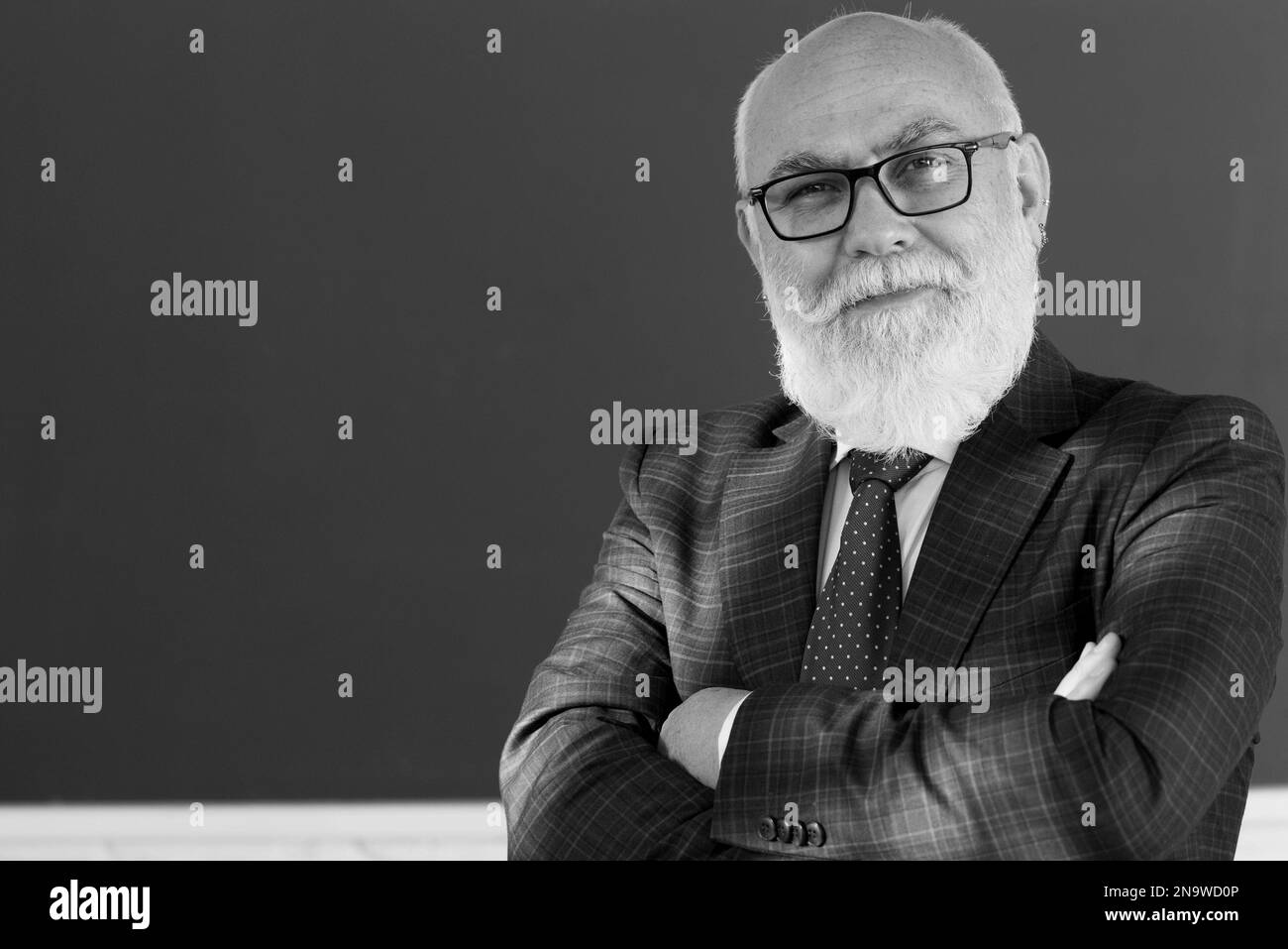 Teacher in the classroom near the blackboard is teaching a lesson ...