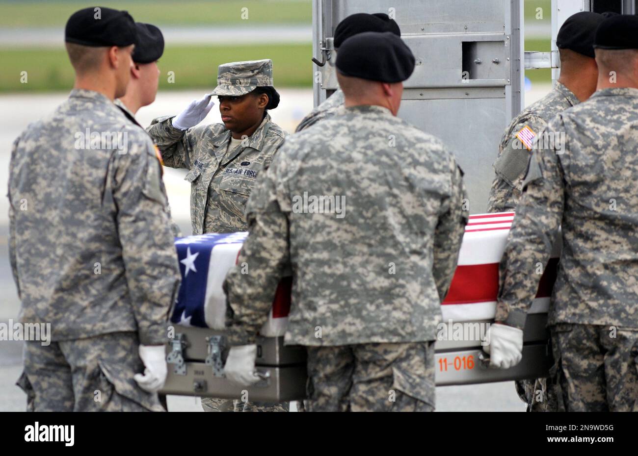 Air Force Senior Airman Mercedes McCoy-Garrett salutes as an Army carry ...