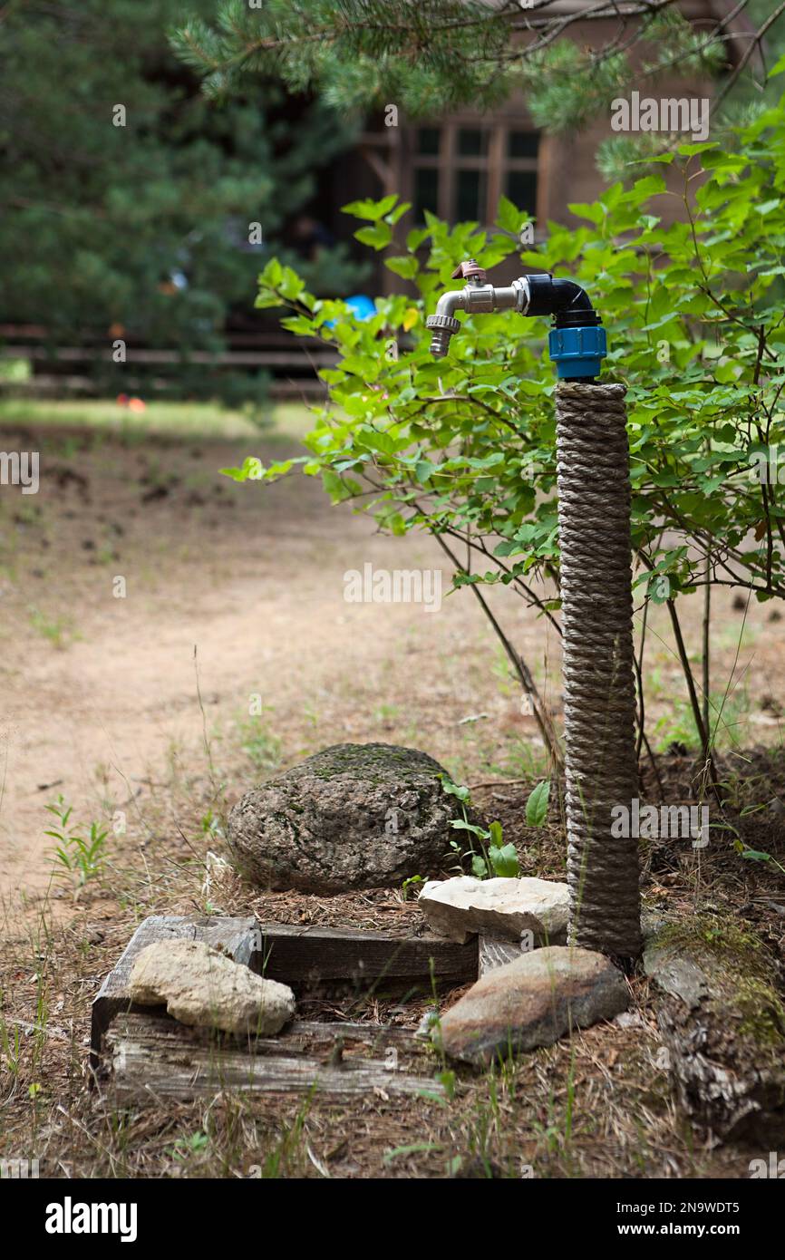 Faucet is in the backyard of the cottage for connecting a hose and ...