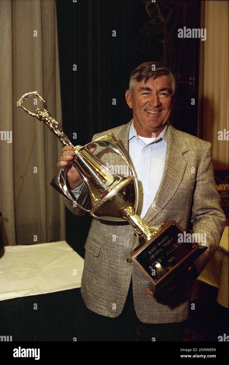 Bobby Allison poses with the Buddy Shuman trophy at a NASCAR press ...