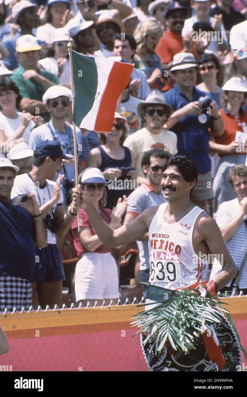 Raul Gonzalez carries the Mexican flag after winning the Men's 50 ...