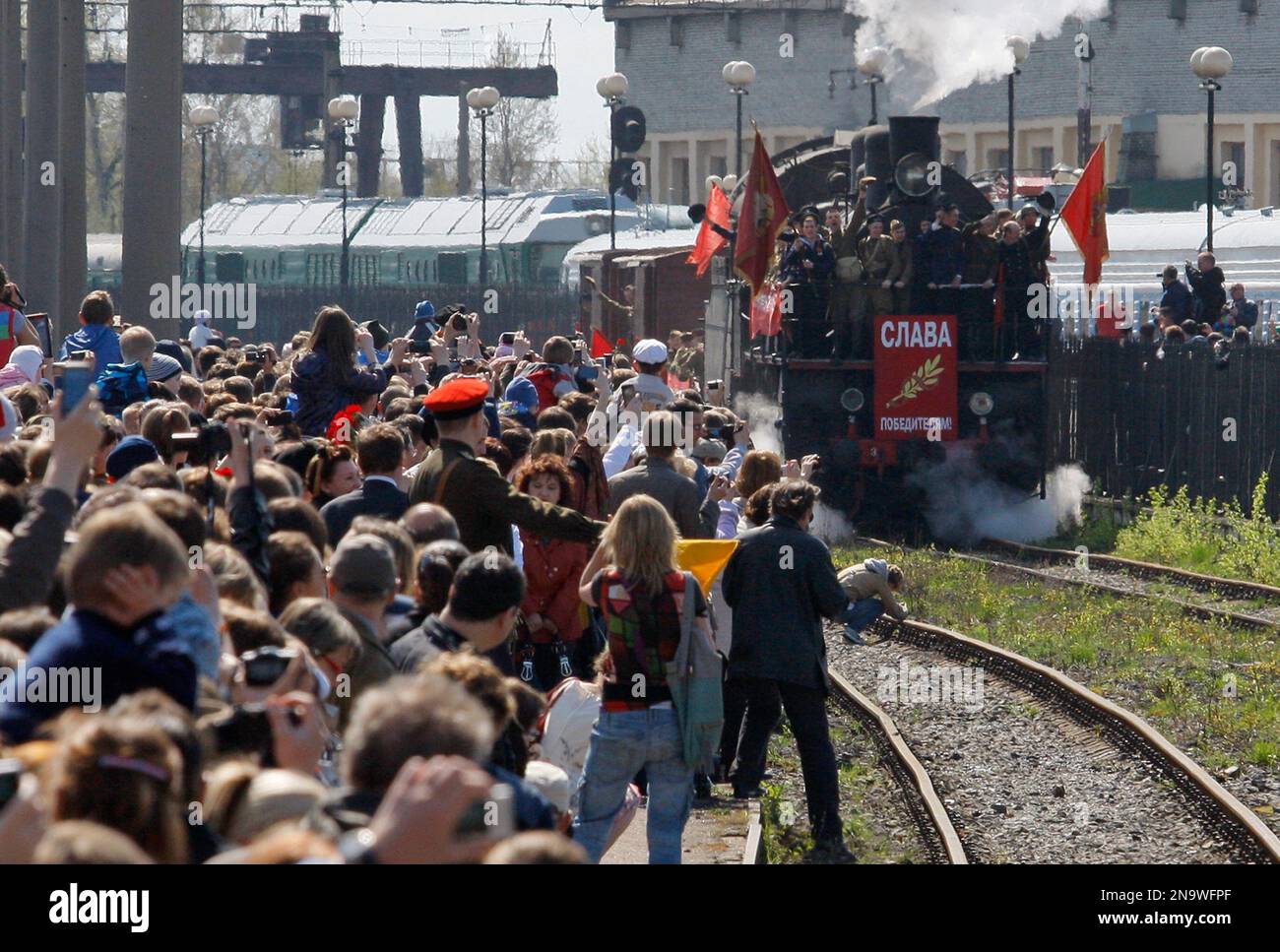 People meet the "Victory train", age-old locomotive with members of a ...