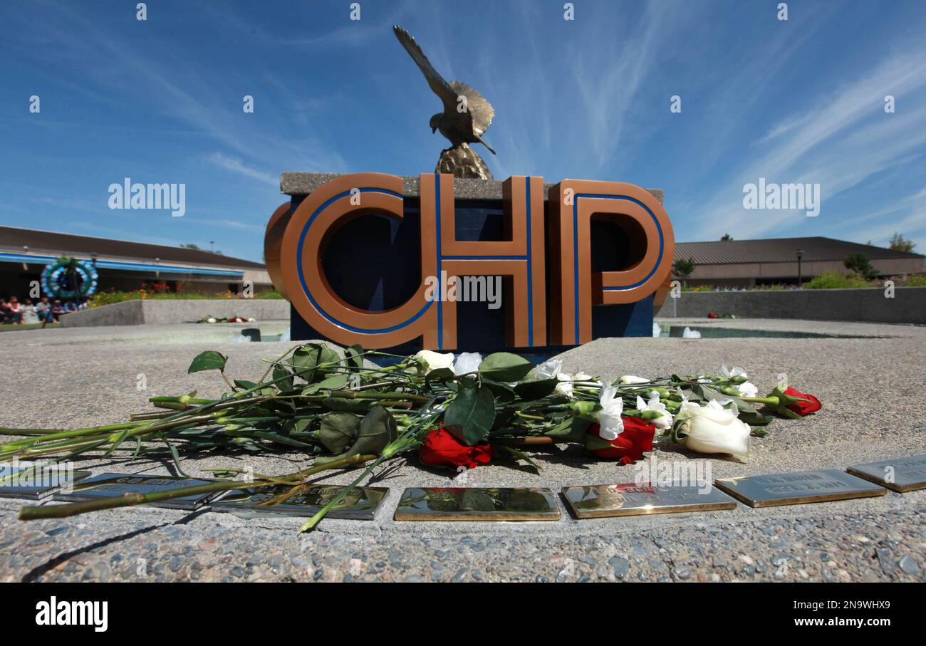 Flowers were placed on the plaques bearing the names of California ...