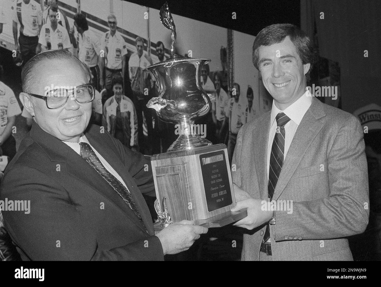 Darrell Waltrip, NASCAR driver, holds trophy presented to NASCAR car ...