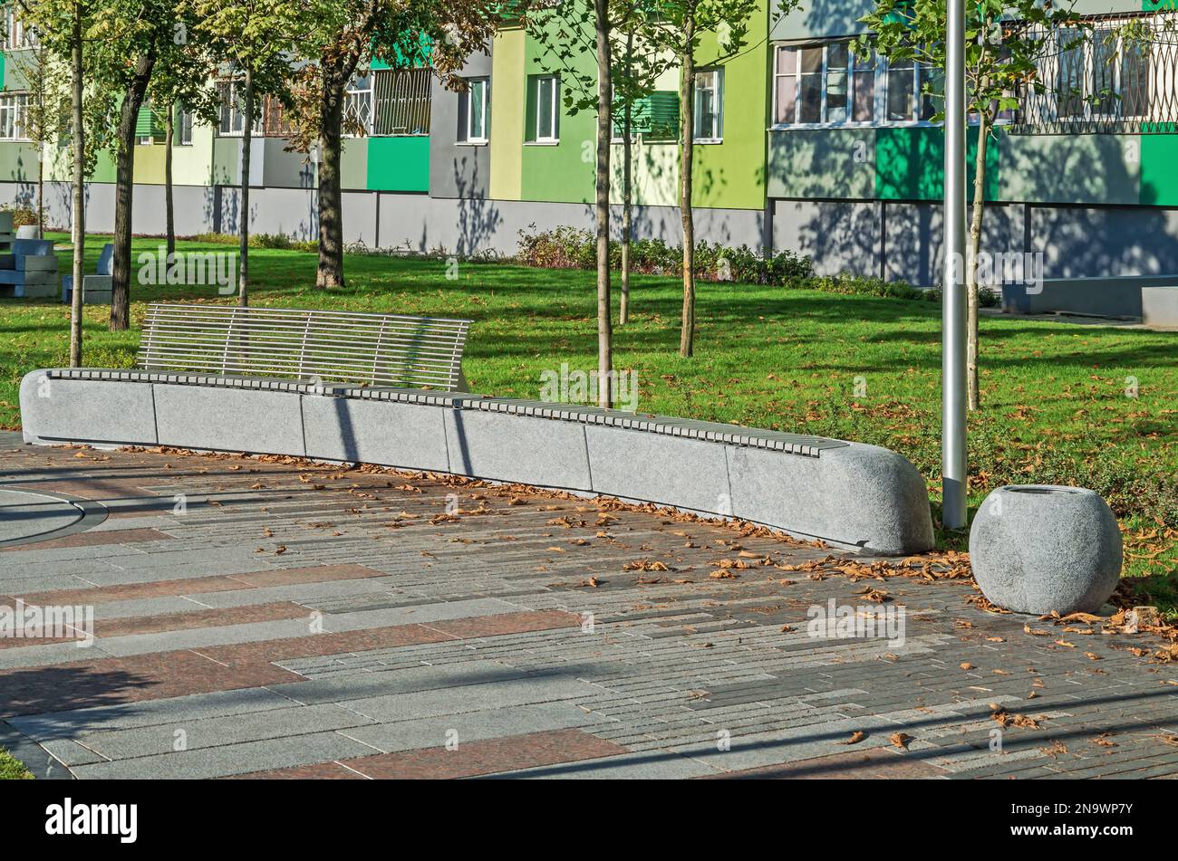 Resting place in courtyard of multistorey building with bench made of ...