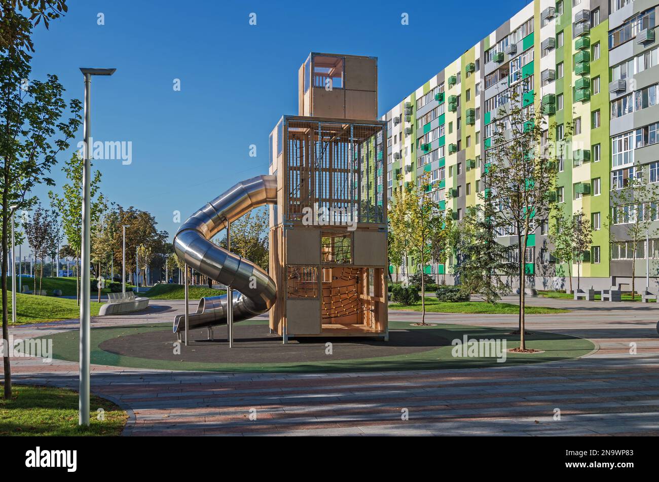 New modern green courtyard of city high-rise buildings with children ...