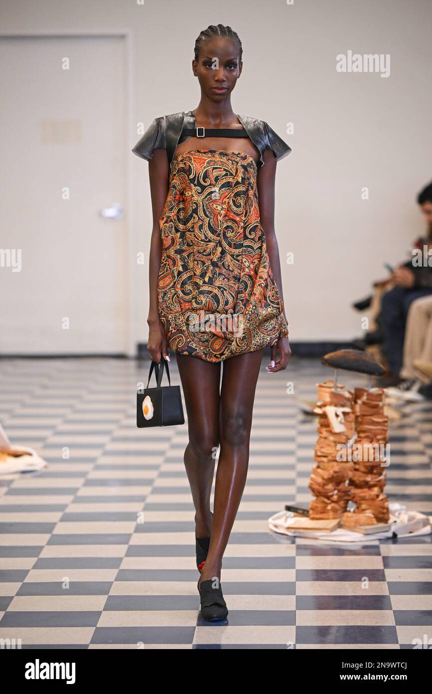 A model walks on the runway at the Puppets and Puppets fashion show ...