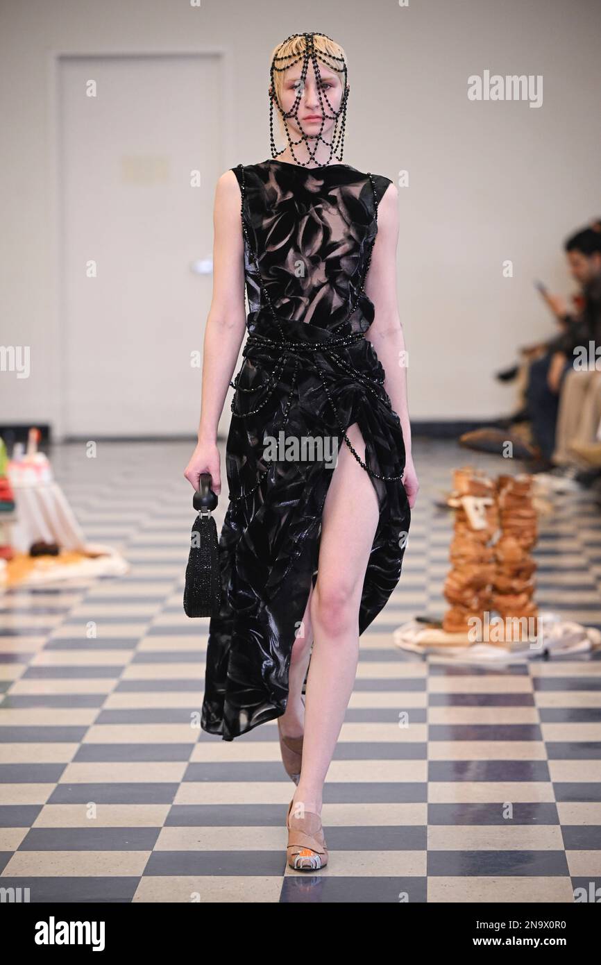 A model walks on the runway at the Puppets and Puppets fashion show ...