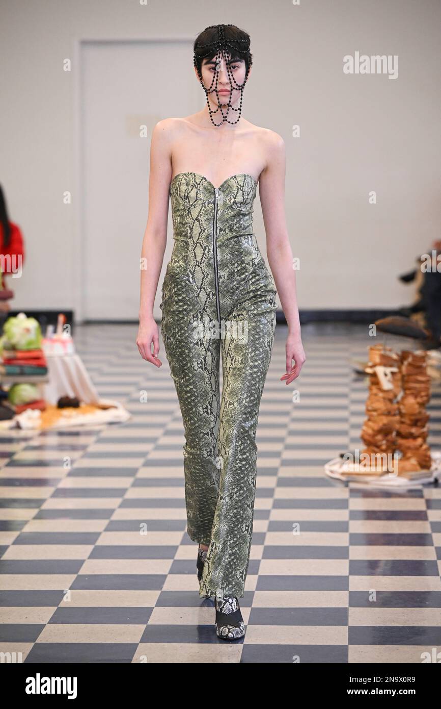 A model walks on the runway at the Puppets and Puppets fashion show ...