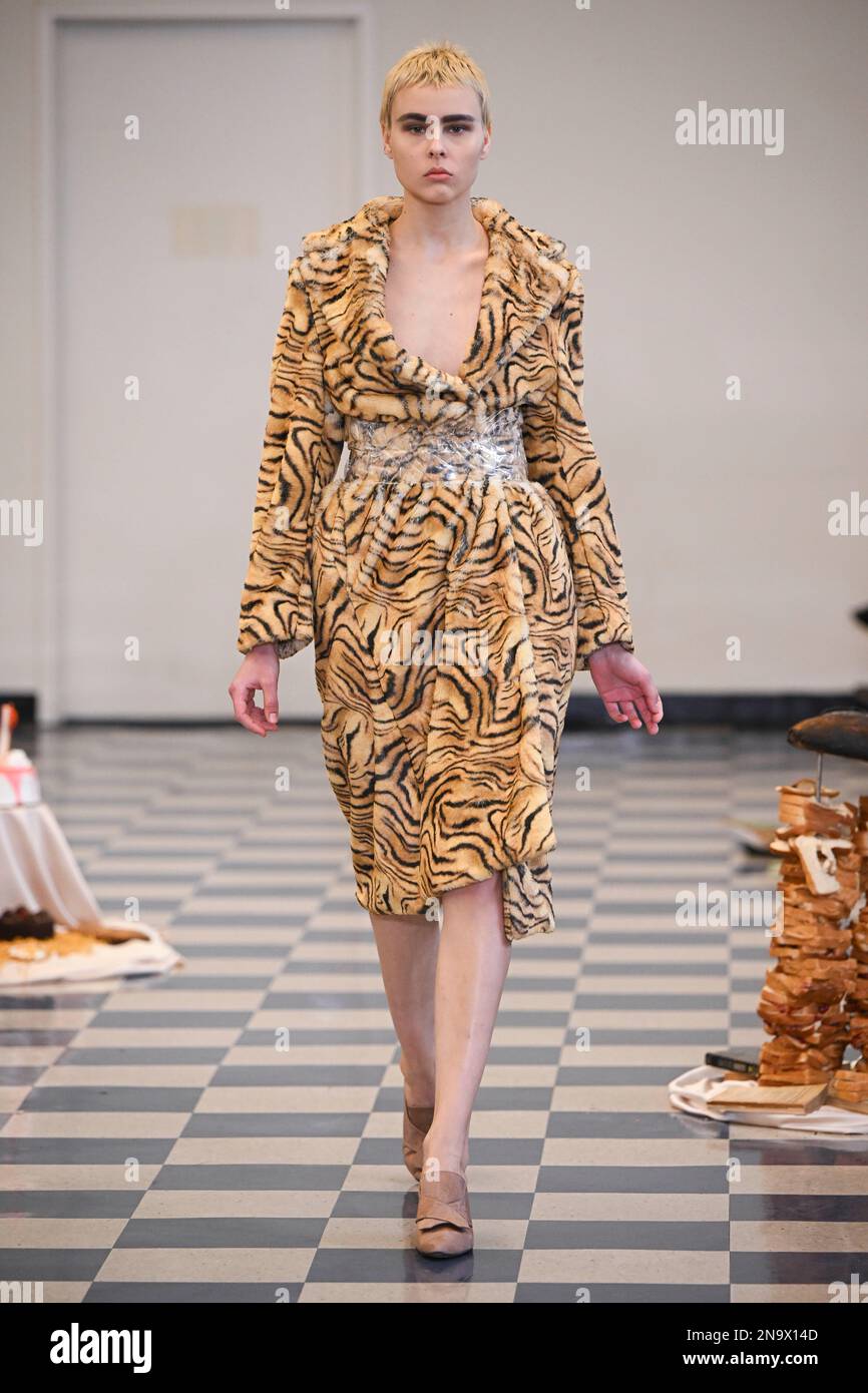 A model walks on the runway at the Puppets and Puppets fashion show ...