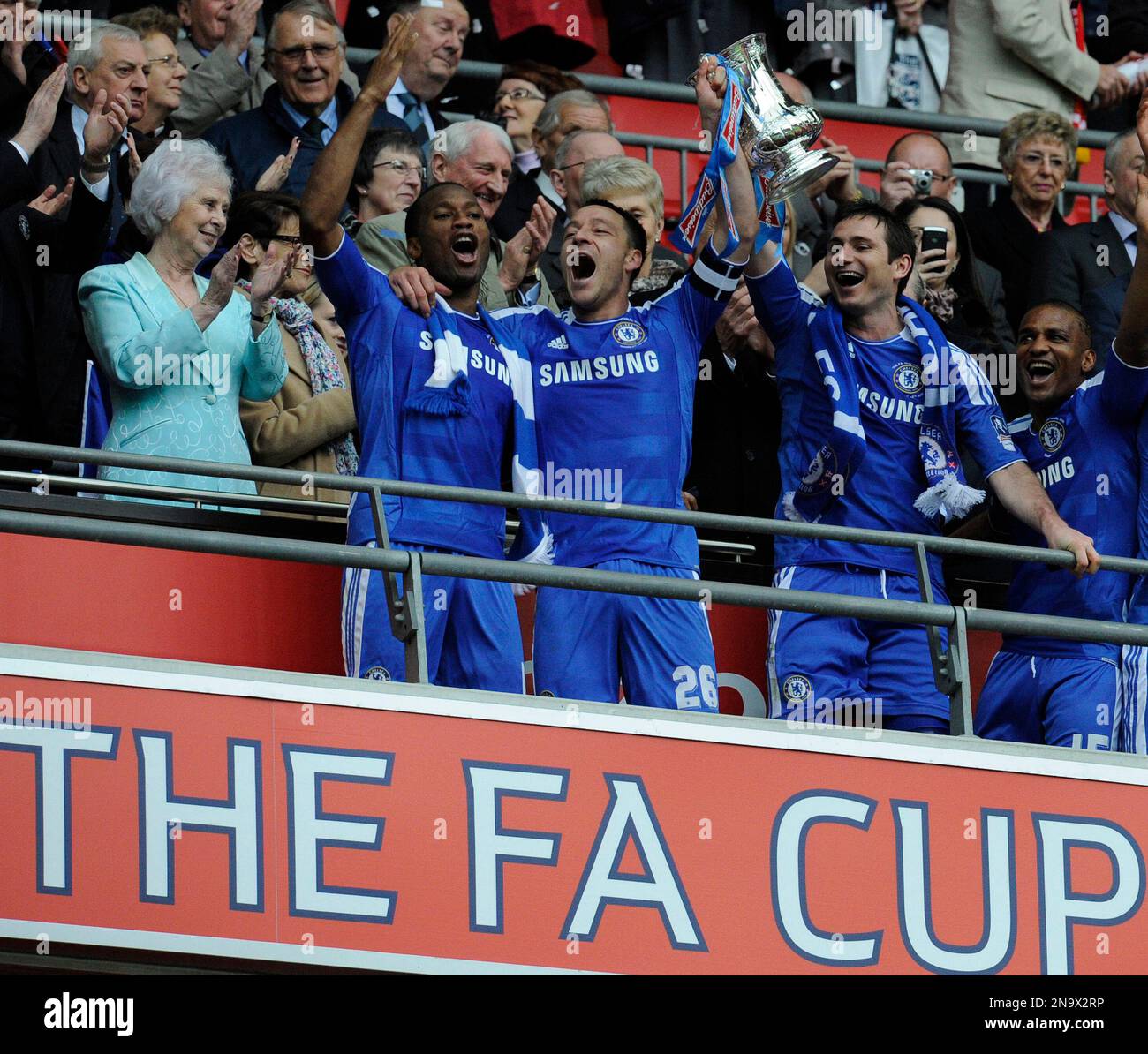 Chelsea's captain John Terry, second left, lifts the FA Cup with ...