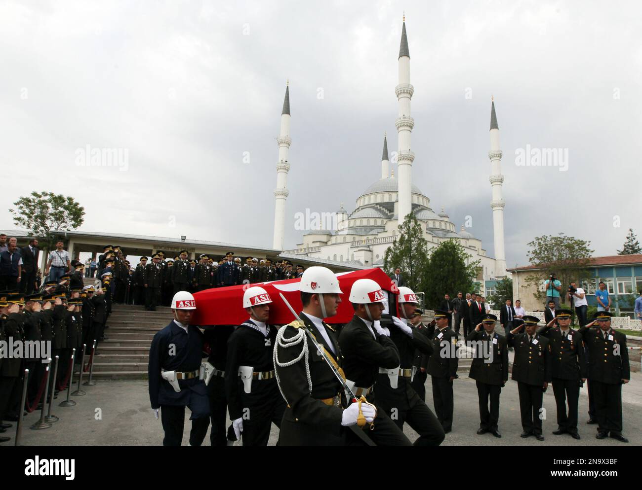 A military guard of honour carry flag-covered coffin of Mehmet Coskun ...