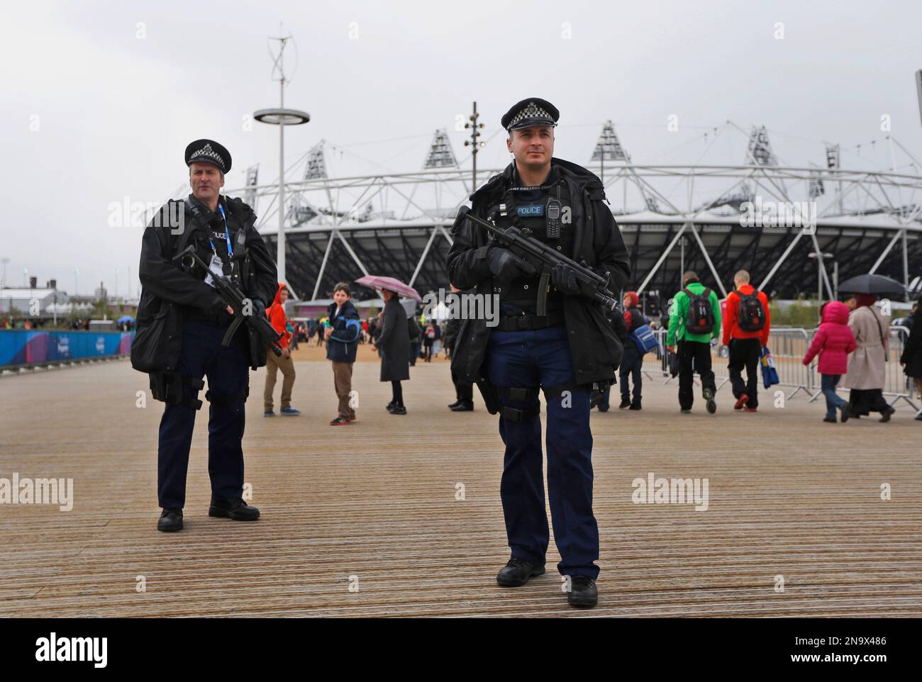 Armed British police officers pose for photographers whilst patrolling ...