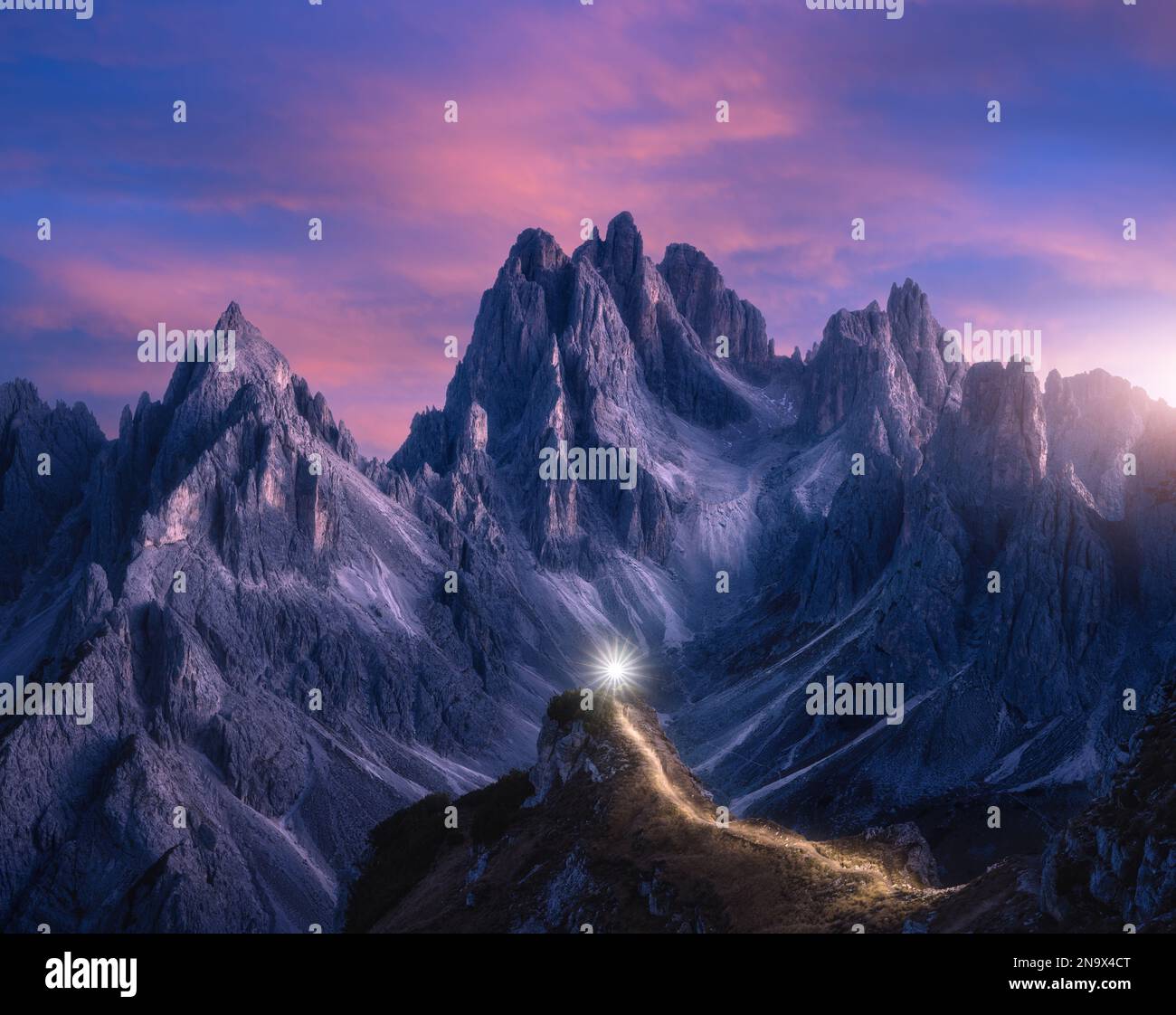 Flashlight trails on mountain path against high rocks at night Stock ...