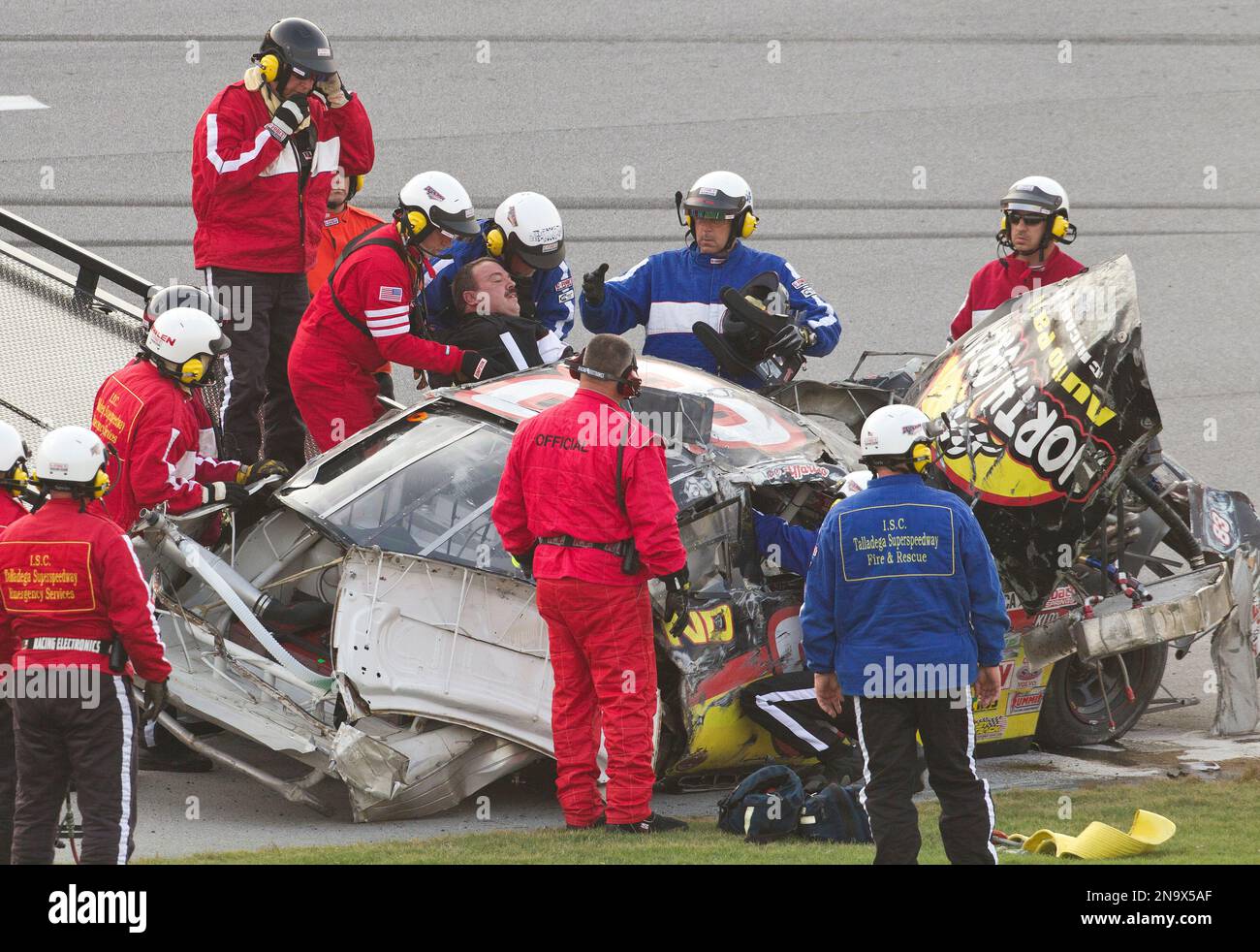 Rescue crews pull Mike Affarano (83) from his car after he flipped on ...