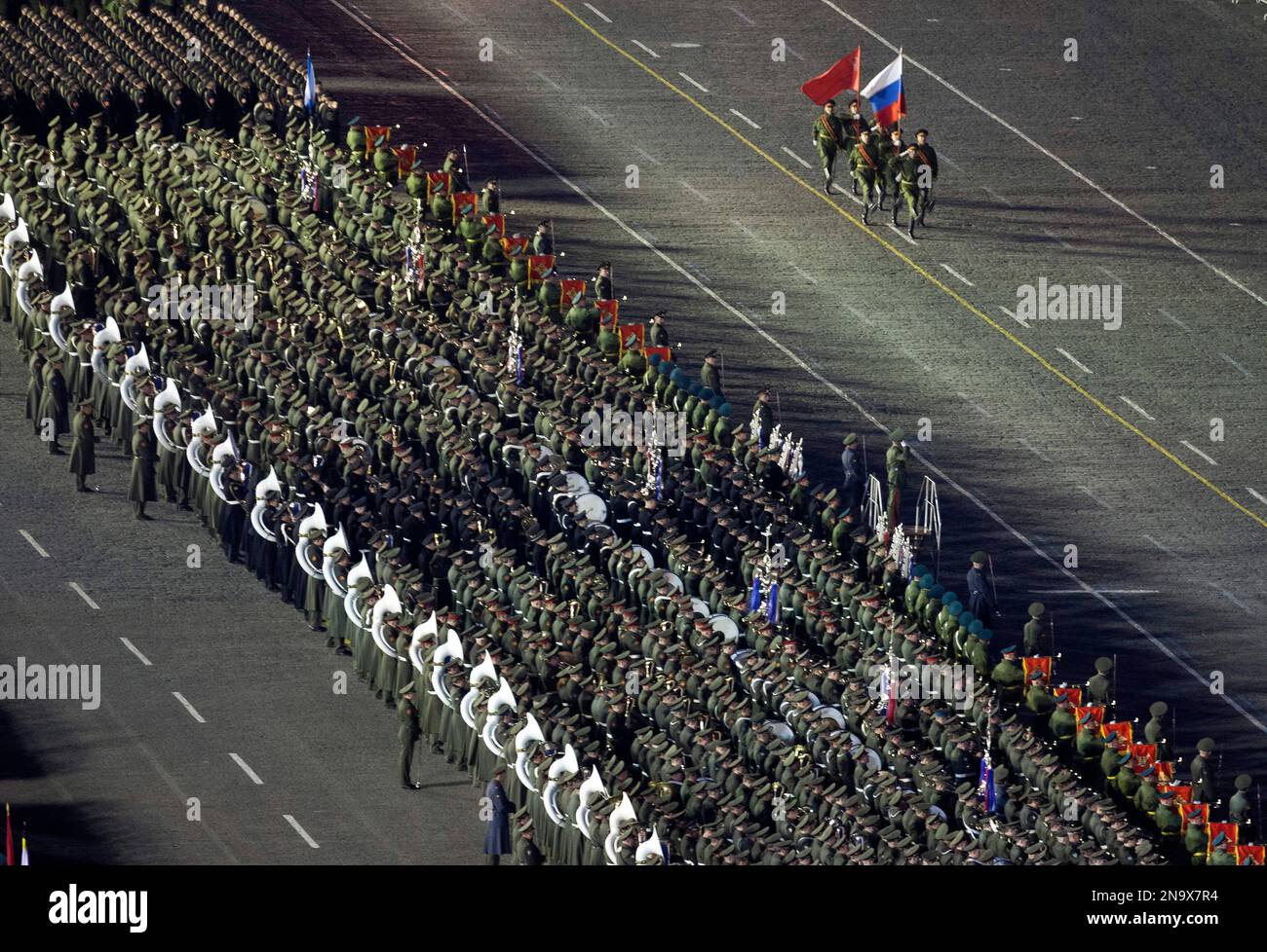 Russian honor guards carry a national flag, left, and replica of the ...