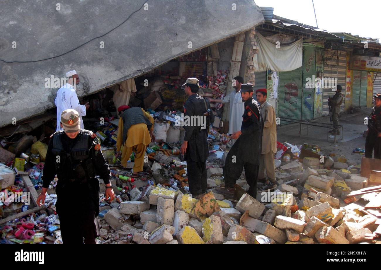Pakistani security personnel visit the site of a suicide bombing in the ...
