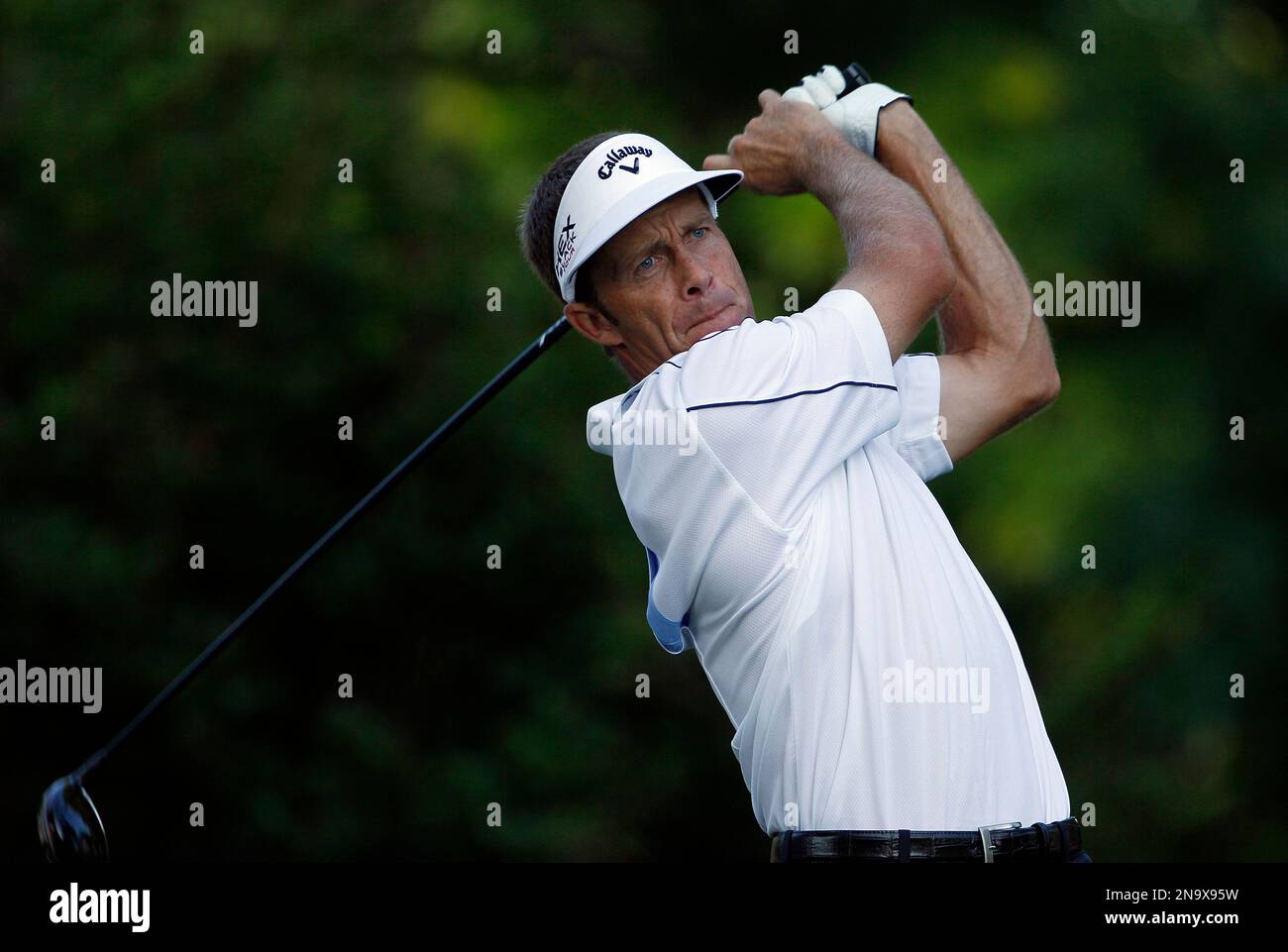 Stuart Appleby, of Australia, watches a tee shot from the third hole ...