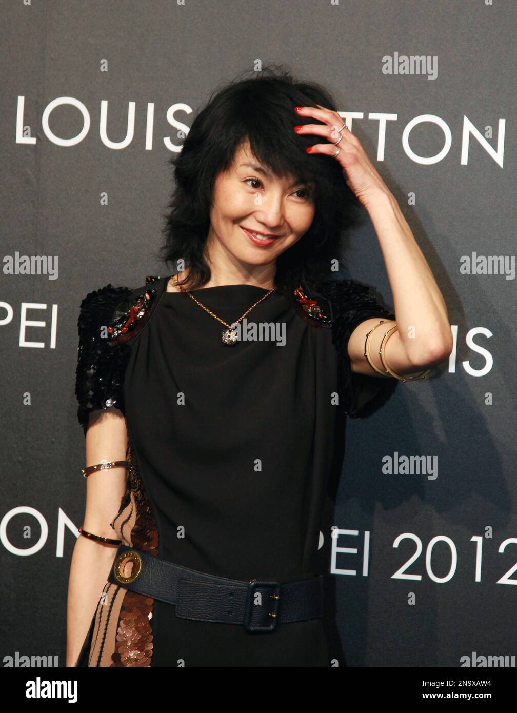 Hong Kong actress Maggie Cheung poses for media as she arrives for the ...