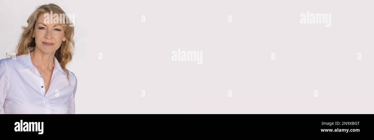 Panoramic attractive happy smiling female middle aged woman studio portrait on a white ...